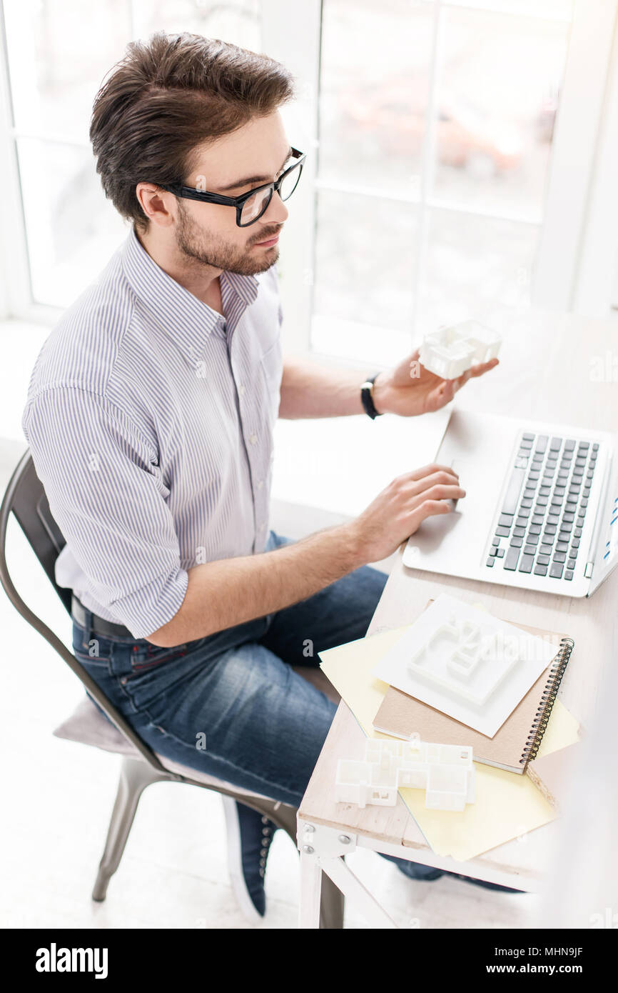Happy man holding a while object Stock Photo - Alamy