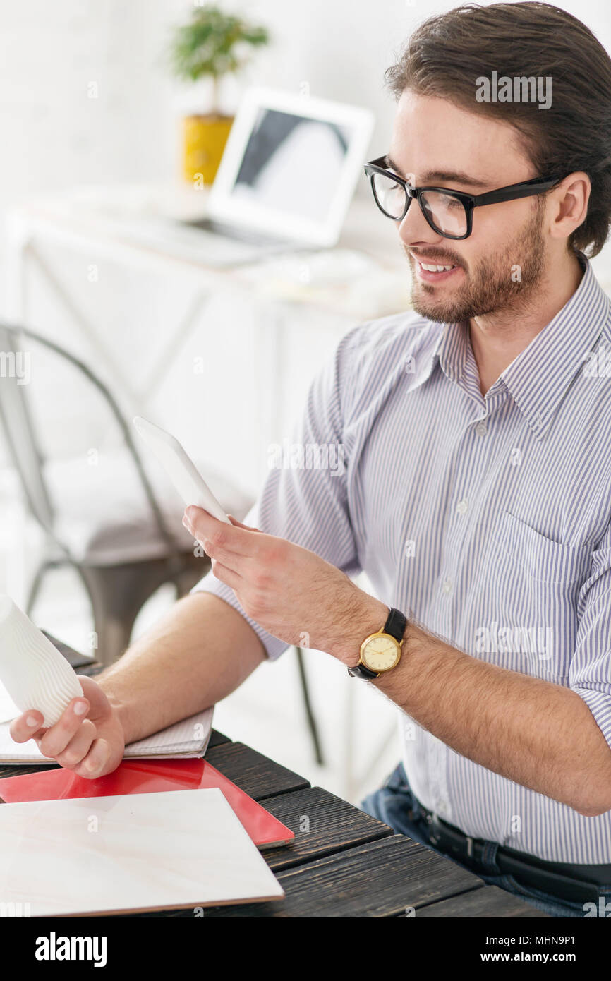 Alert man taking pictures of a white object Stock Photo - Alamy