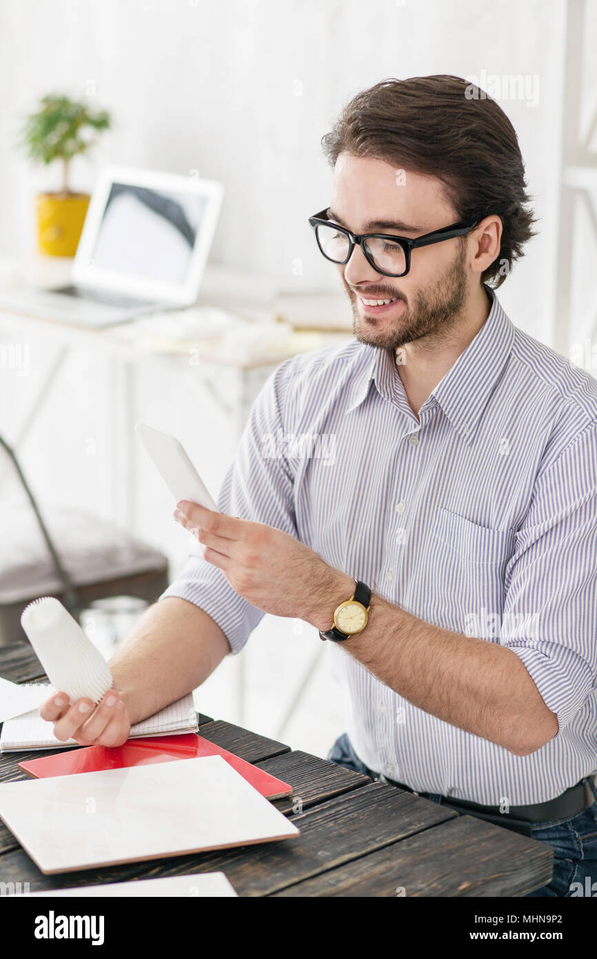 Content man taking pictures of a white object Stock Photo - Alamy