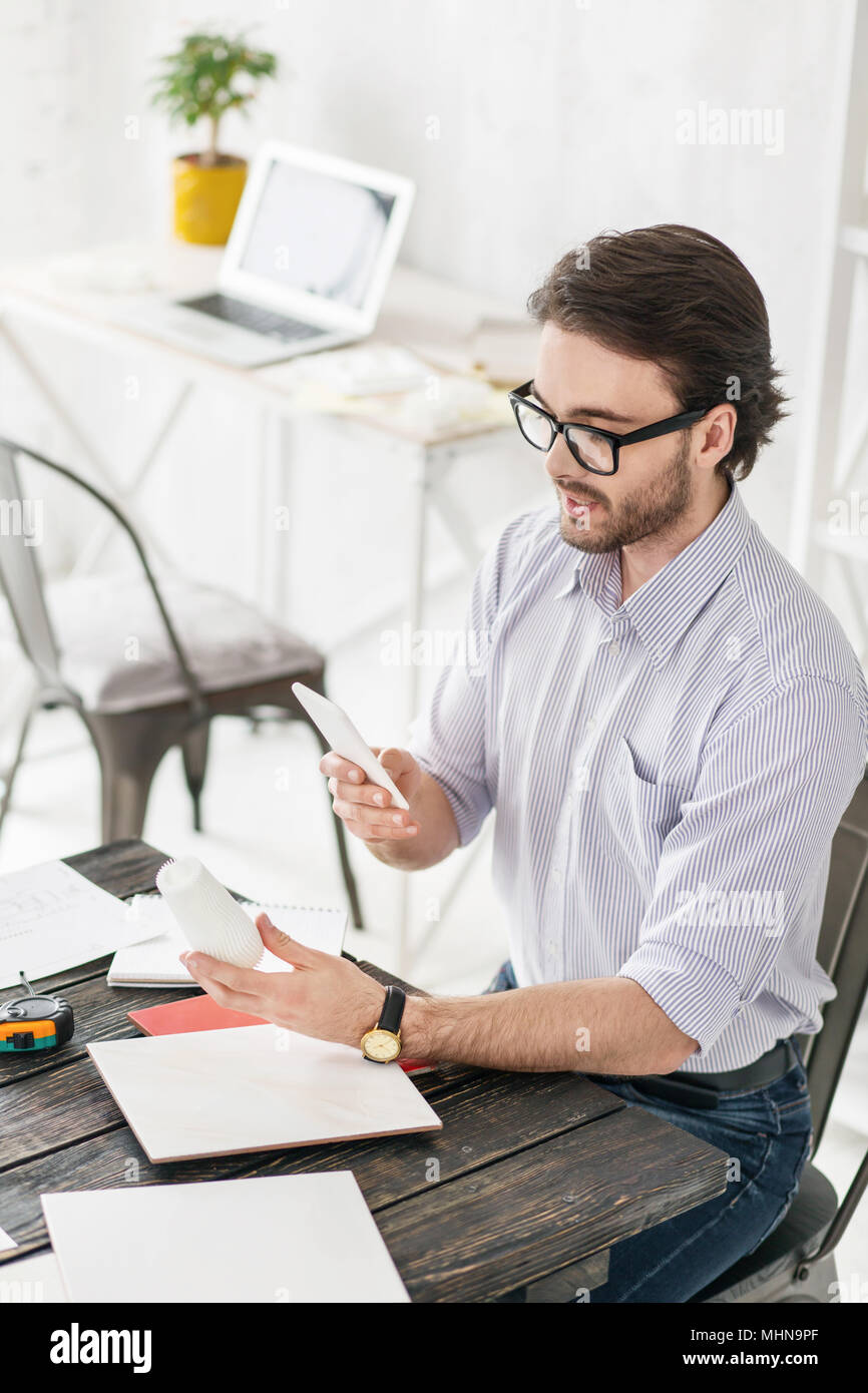 Inspired man taking pictures of a white object Stock Photo - Alamy