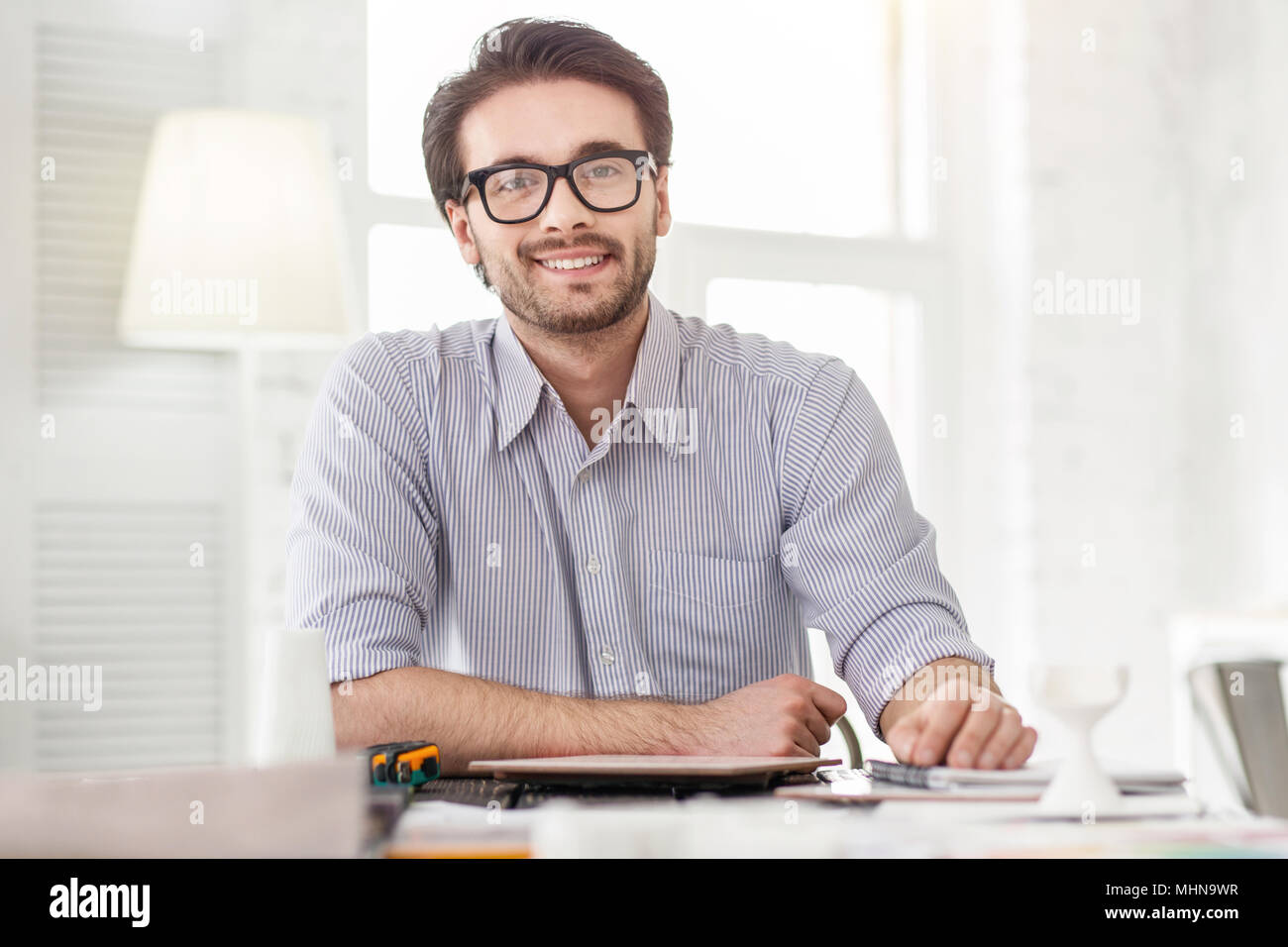 Pleased manager sitting in his office Stock Photo - Alamy