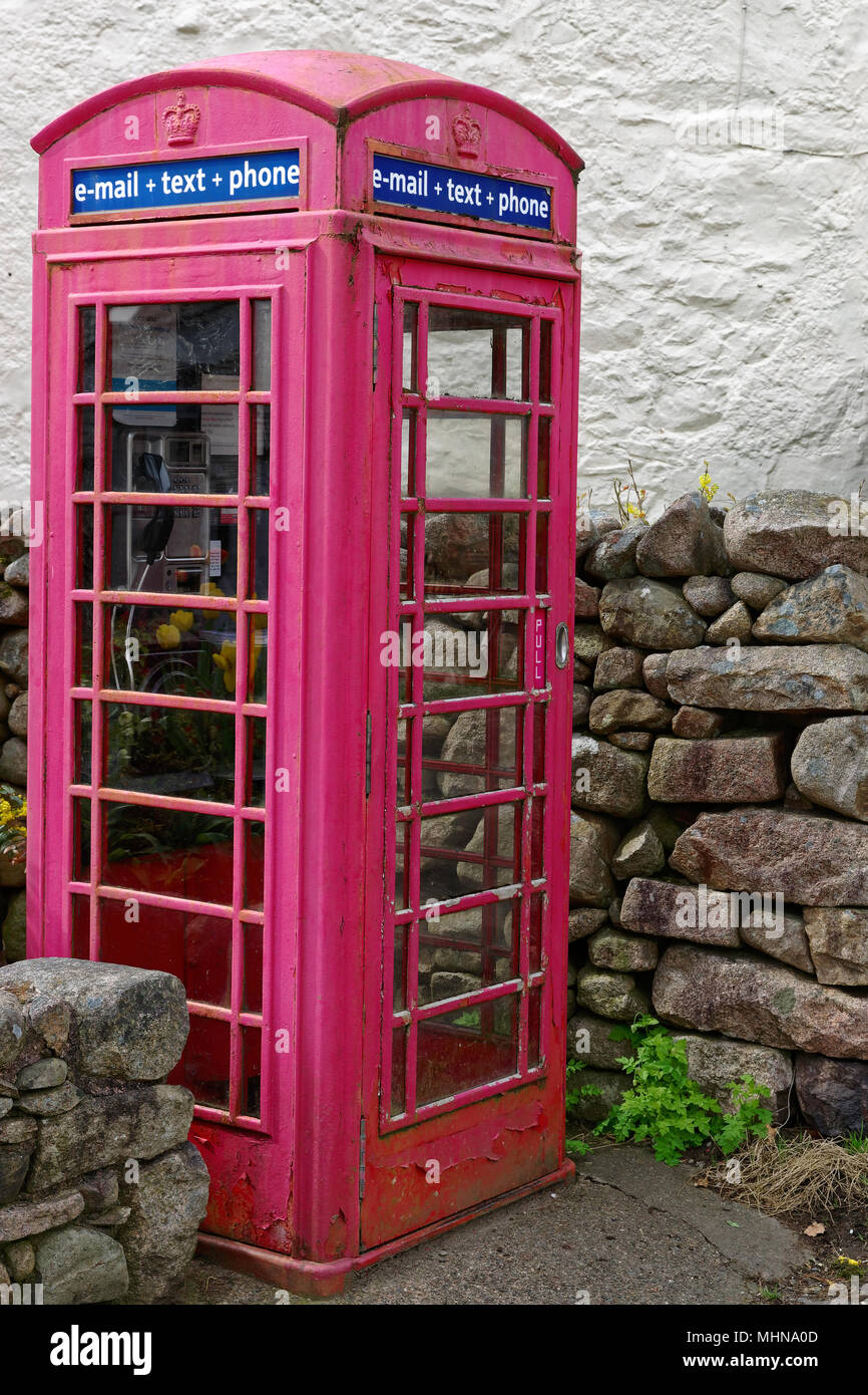Old fashioned red telephone box offering e-mail text and phone services ...