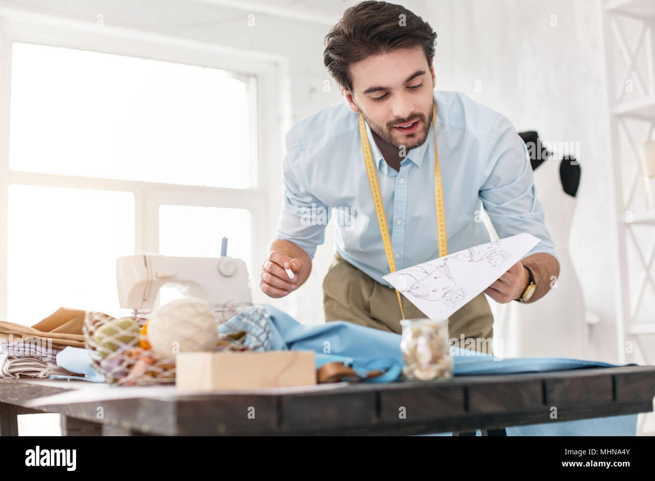 Inspired professional tailor working on a sewing machine Stock Photo ...