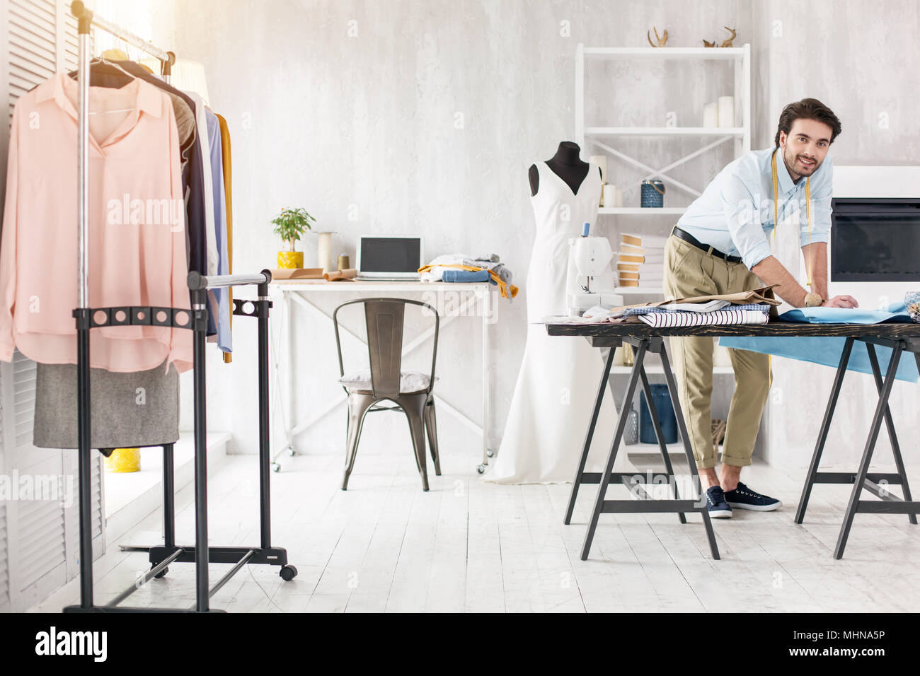 Inspired dressmaker making a new dress Stock Photo - Alamy