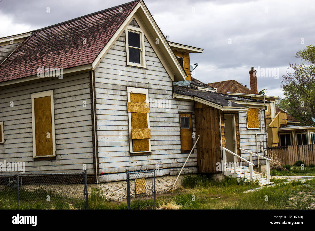 Abandoned Home With Boarded Up Windows Stock Photo - Alamy