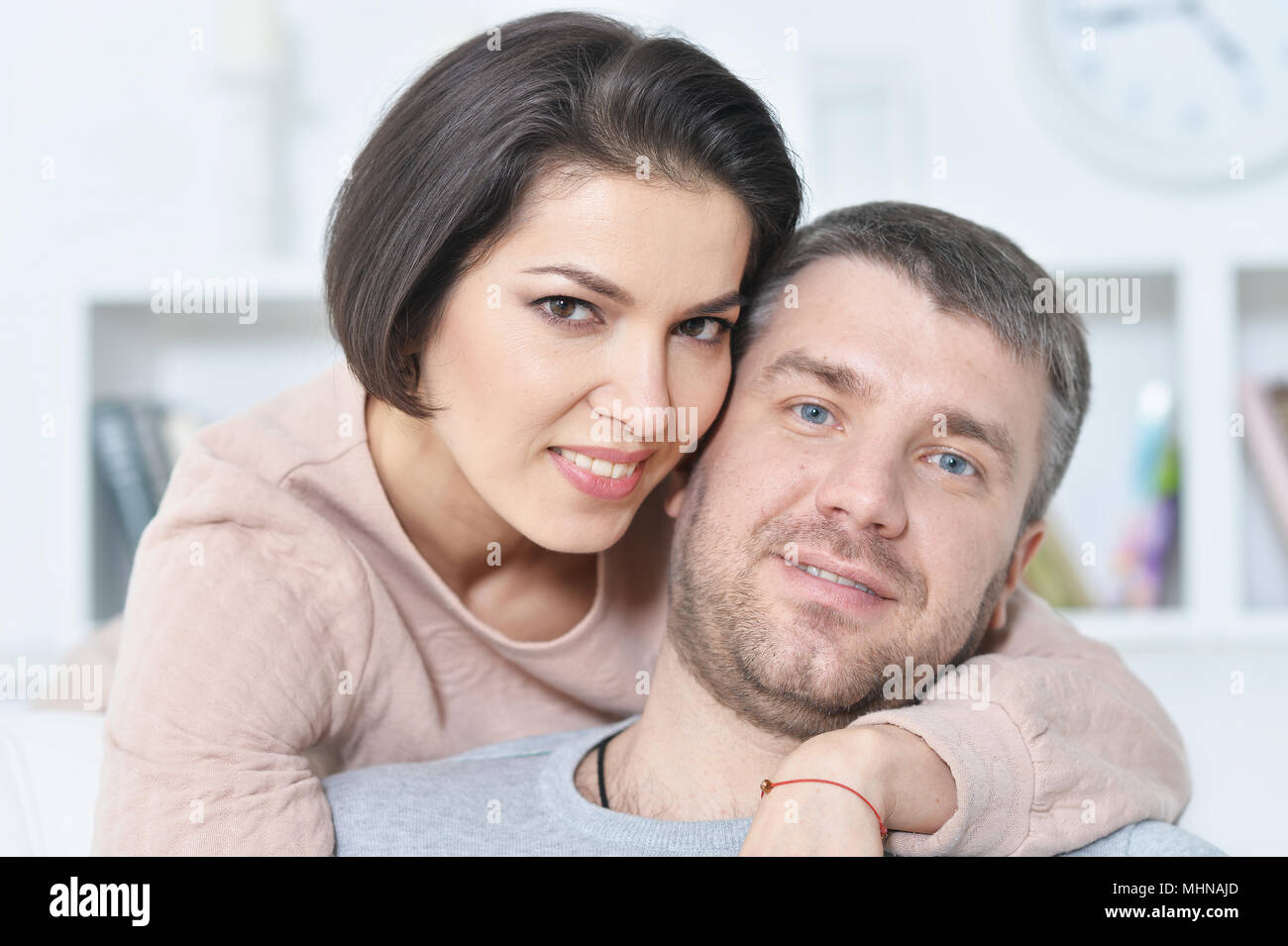 Portrait of couple hugging Stock Photo - Alamy