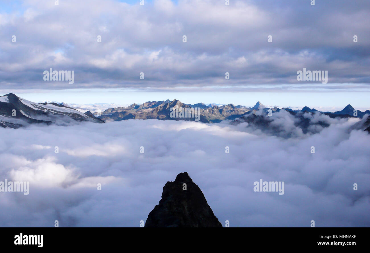 sharp mountain peak and great landscape behind with cloud cover in the ...