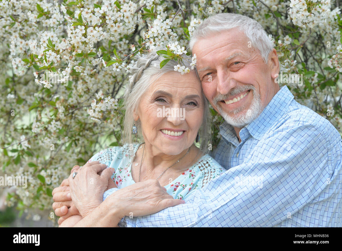 couple hugging in blooming garden Stock Photo - Alamy