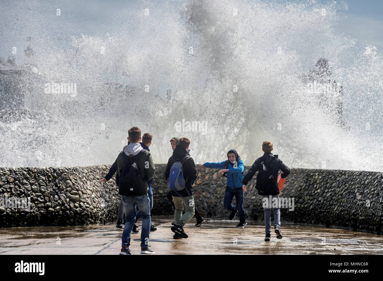 A group of German students are surprised by a sudden wave during rough ...