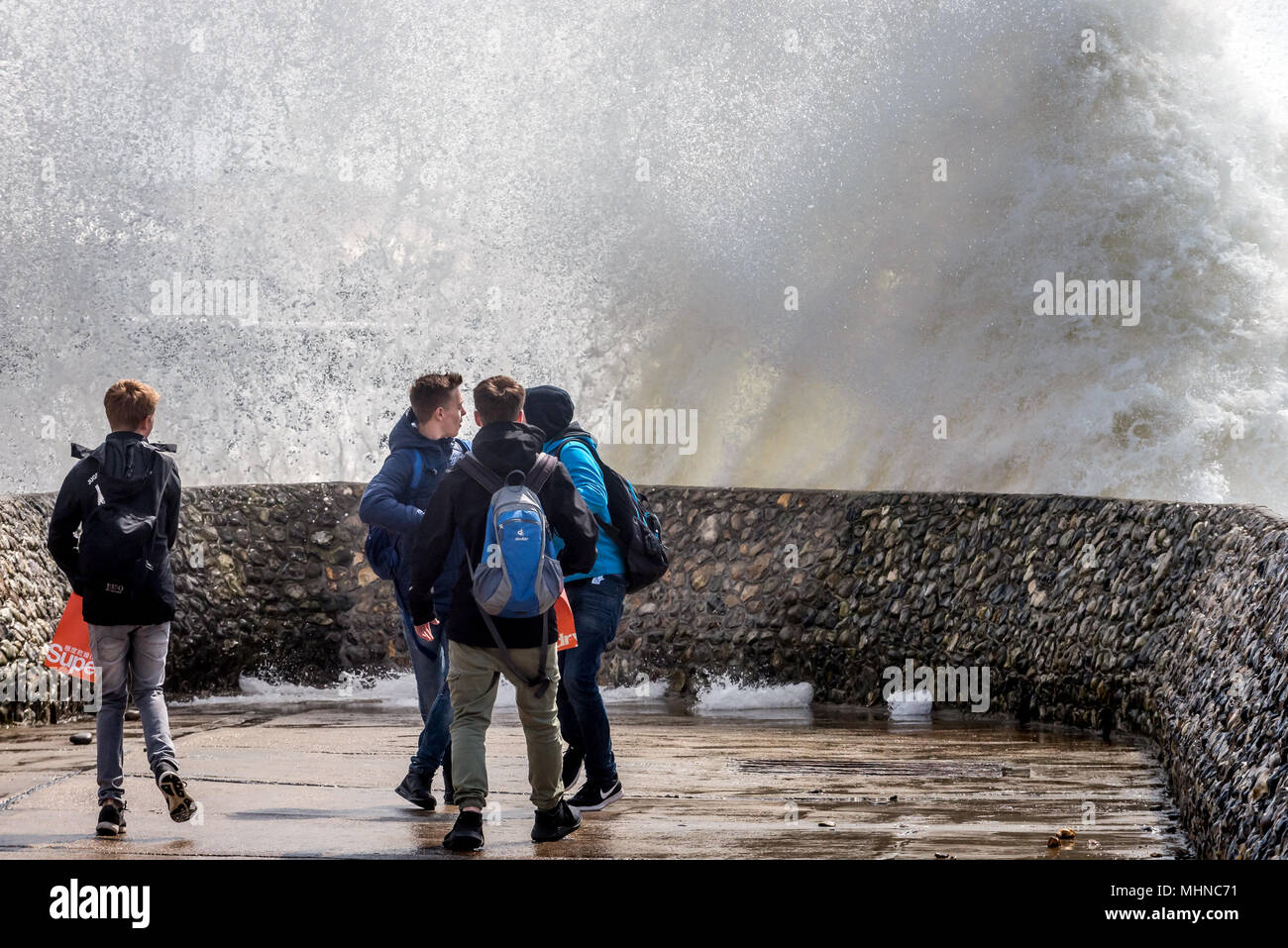 A group of German students are surprised by a sudden wave during rough ...
