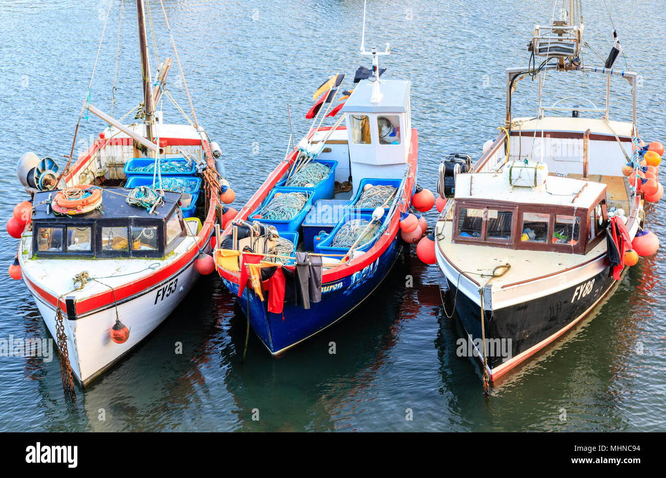 Inshore fishing boats or trawlers moored in Mevagissey harbour in ...
