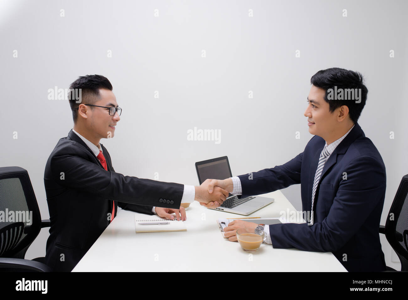 Dealer attending to a customer in a desktop in the office Stock Photo ...