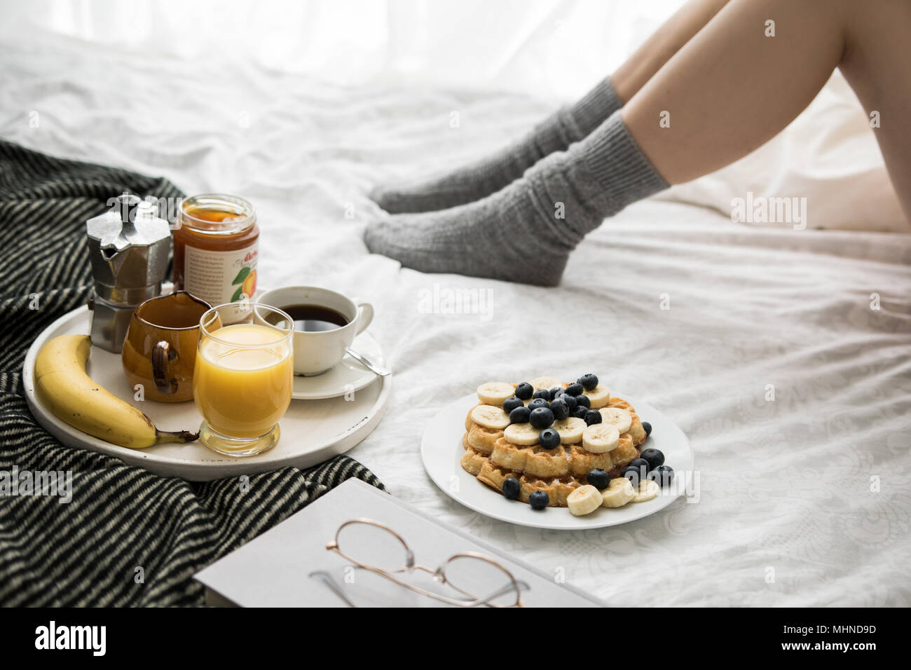 Cozy breakfast scene in bed with waffles on a sunny weekend Stock Photo ...