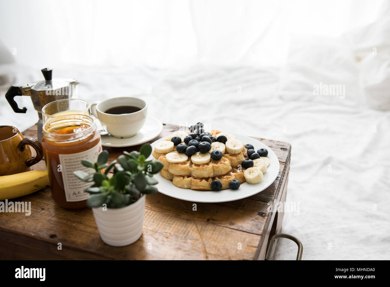 Cozy breakfast scene in bed with waffles on a sunny weekend Stock Photo ...