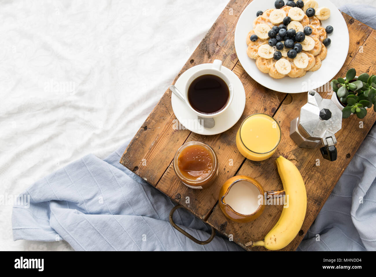 Cozy breakfast scene in bed with waffles on a sunny weekend Stock Photo ...