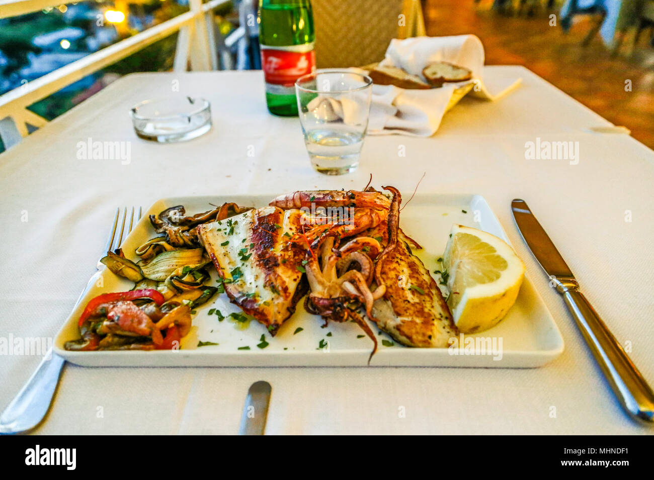 Grilled Fishes at dinner at Italian restaurant Stock Photo - Alamy