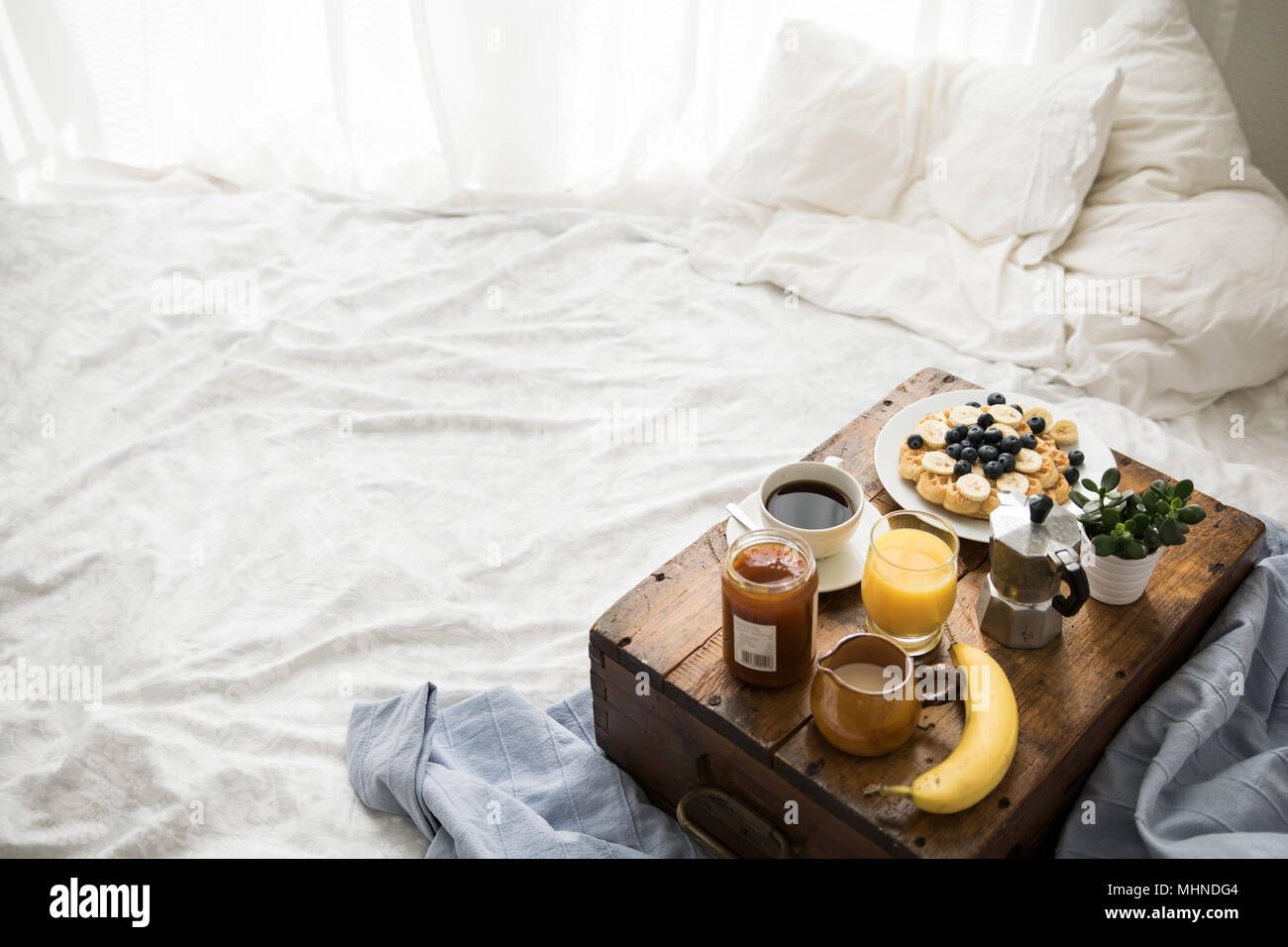 Cozy breakfast scene in bed with waffles on a sunny weekend Stock Photo ...