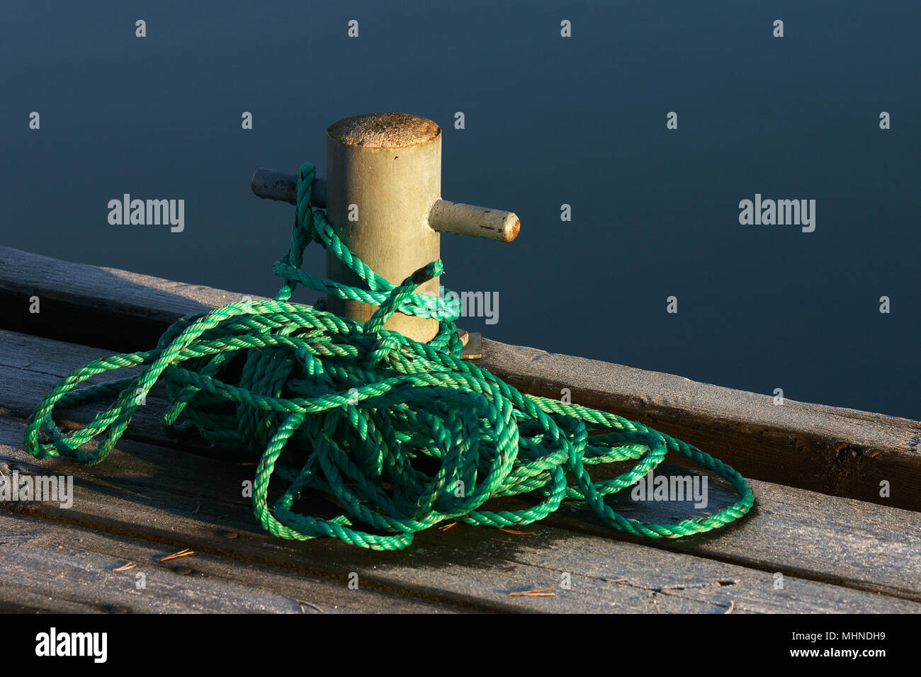 A tangled nylon rope on a bollard shows disarray Stock Photo - Alamy