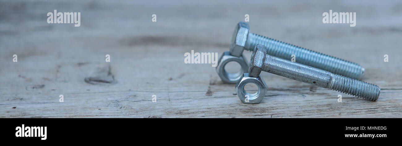 Bolts and nuts on the wooden table for commercial use are used, copy ...