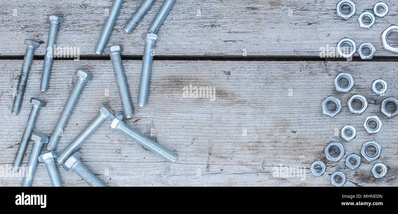 Bolts and nuts on the wooden table for commercial use are used, copy ...