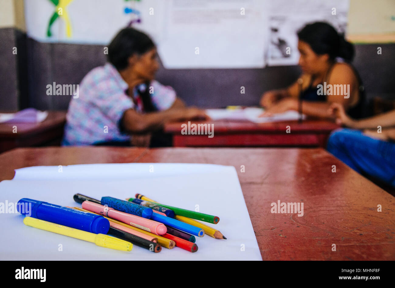Colors and crayons and women's background in the school Stock Photo - Alamy