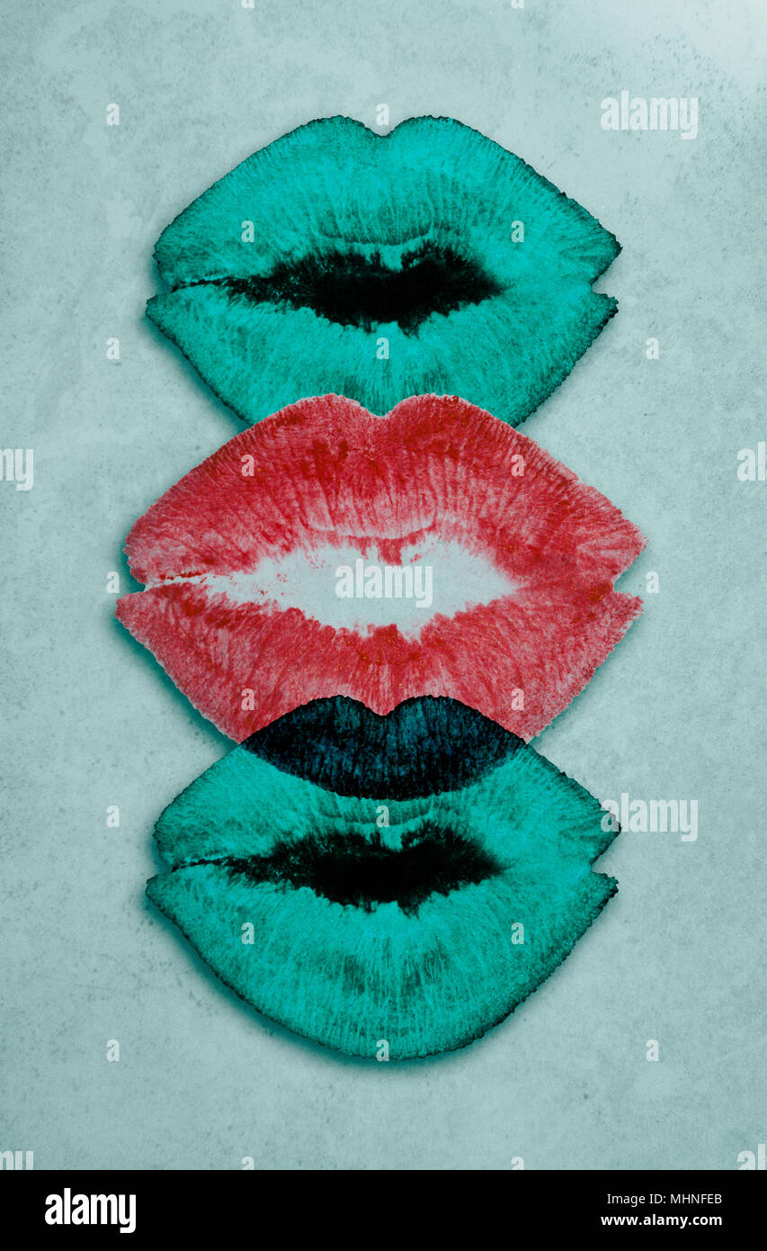 Illustration of three overlaid lips, two green and one red, on a blue ...