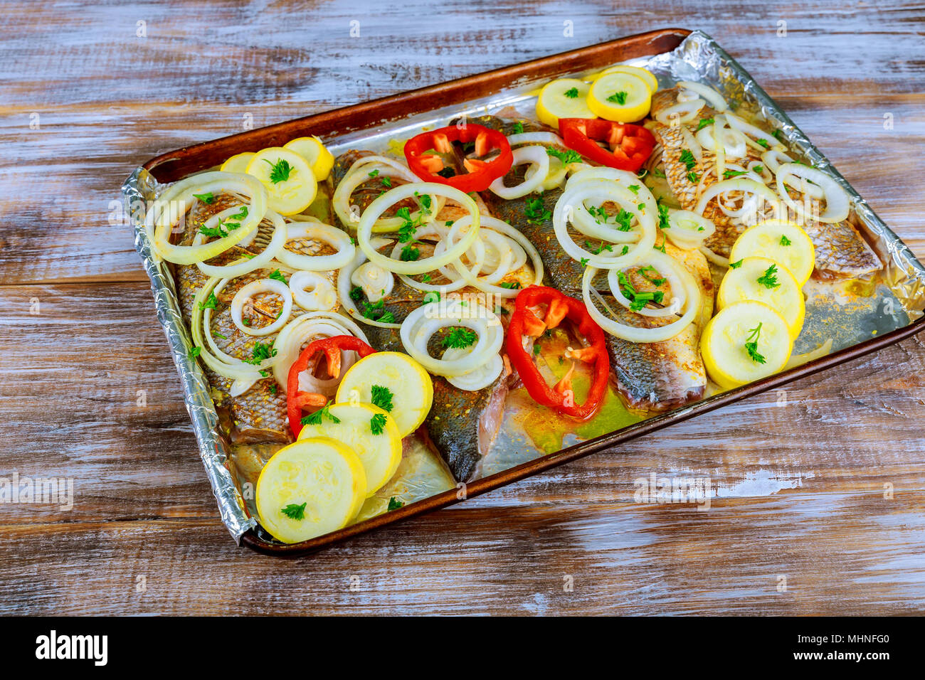 fresh fish fillet with ingredients for cooking on wooden table Stock ...