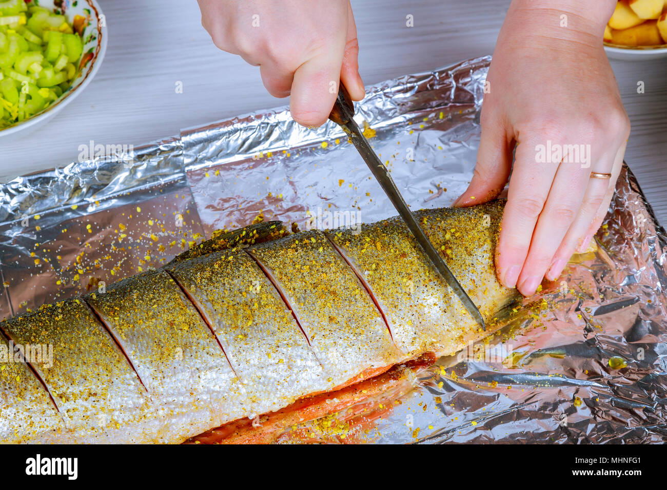 Raw fish. Cutting fresh salmon women's hands Stock Photo - Alamy