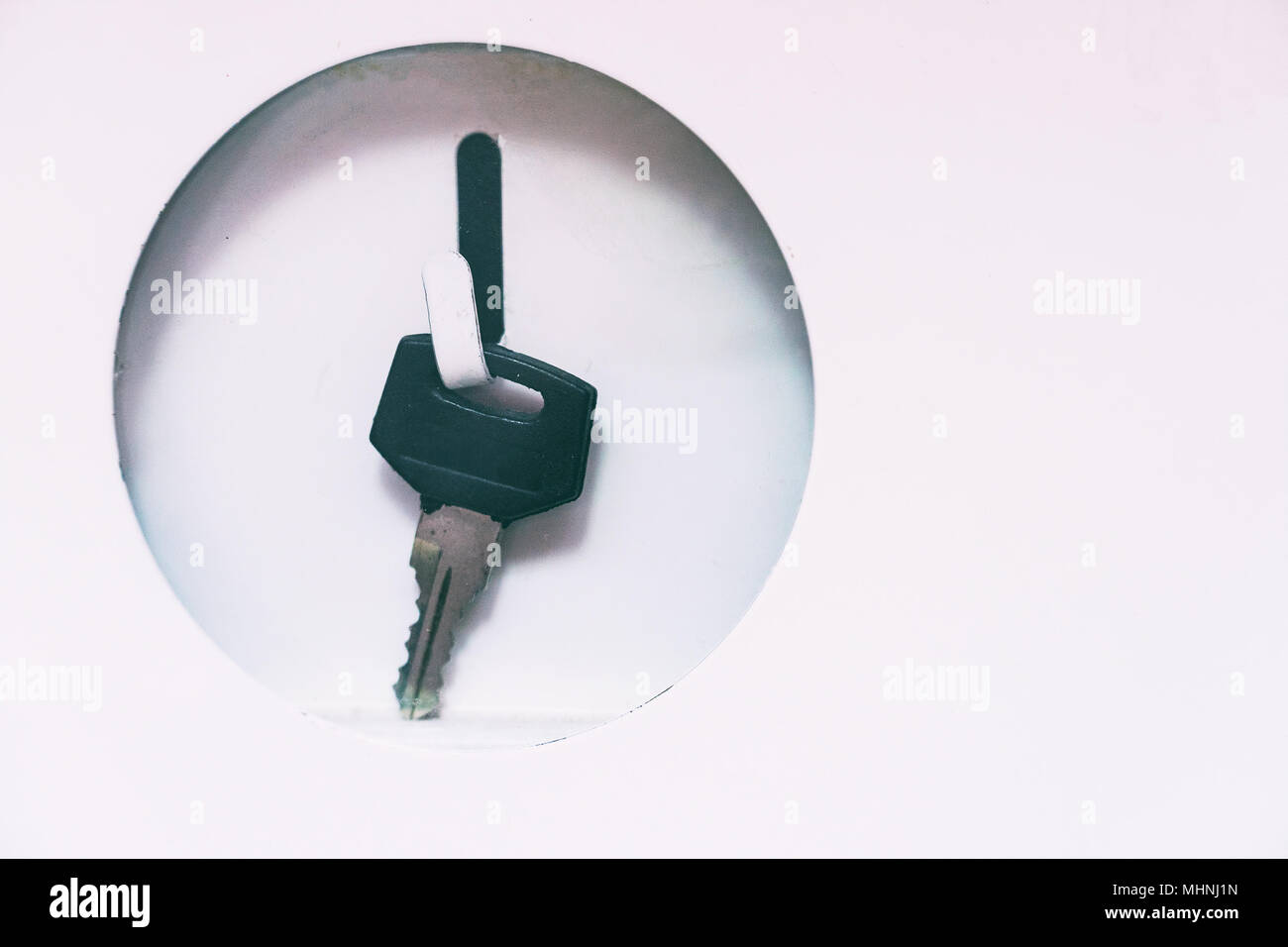 Key on the hook in a small round window Stock Photo - Alamy