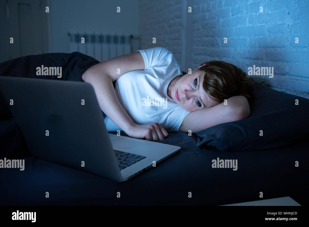 young beautiful caucasian red haired internet addicted woman working ...