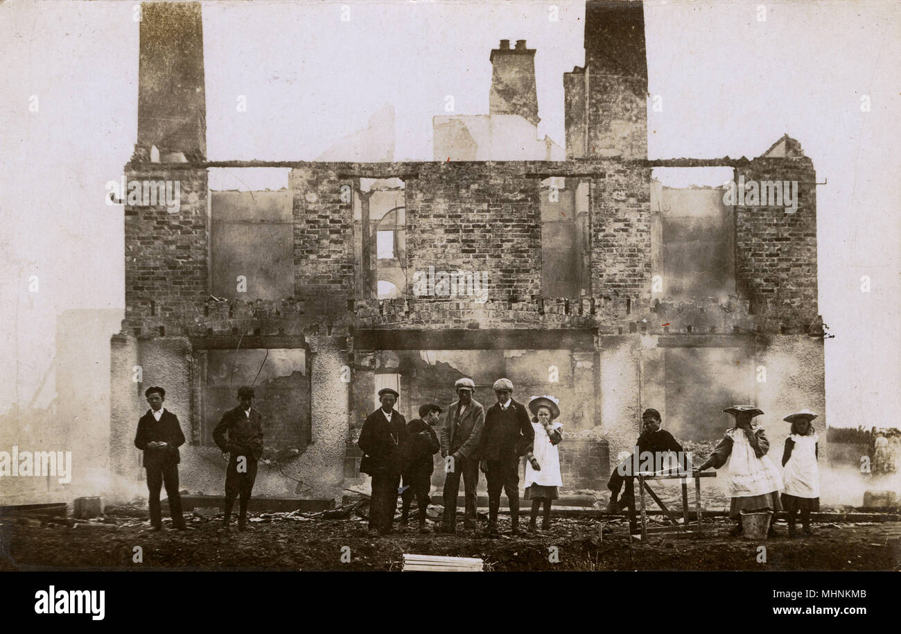 Smouldering remains of large country house destroyed by fire Stock ...