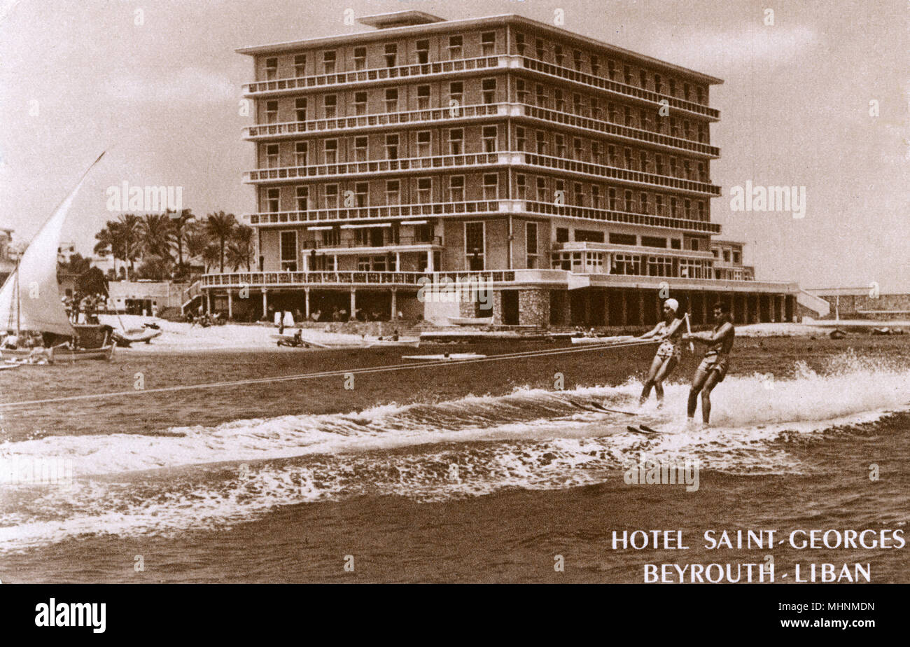 A couple water skiing passed the Hotel Saint Georges, Beirut, Lebanon ...