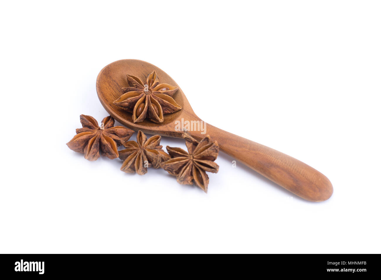 Star anise in wooden kitchen spoon isolated on white background Stock ...