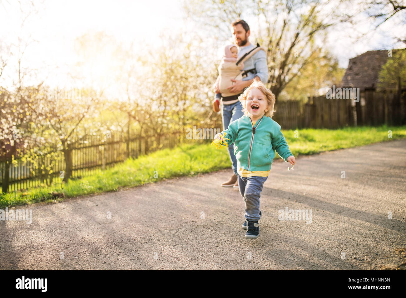 A father with his toddler children outside on a spring walk Stock Photo ...