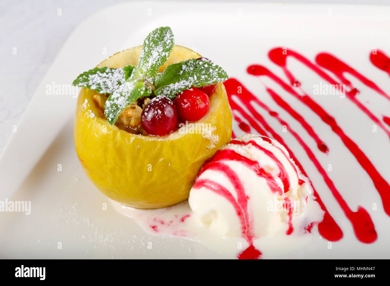 Apple stuffed nuts with ice-cream Stock Photo - Alamy