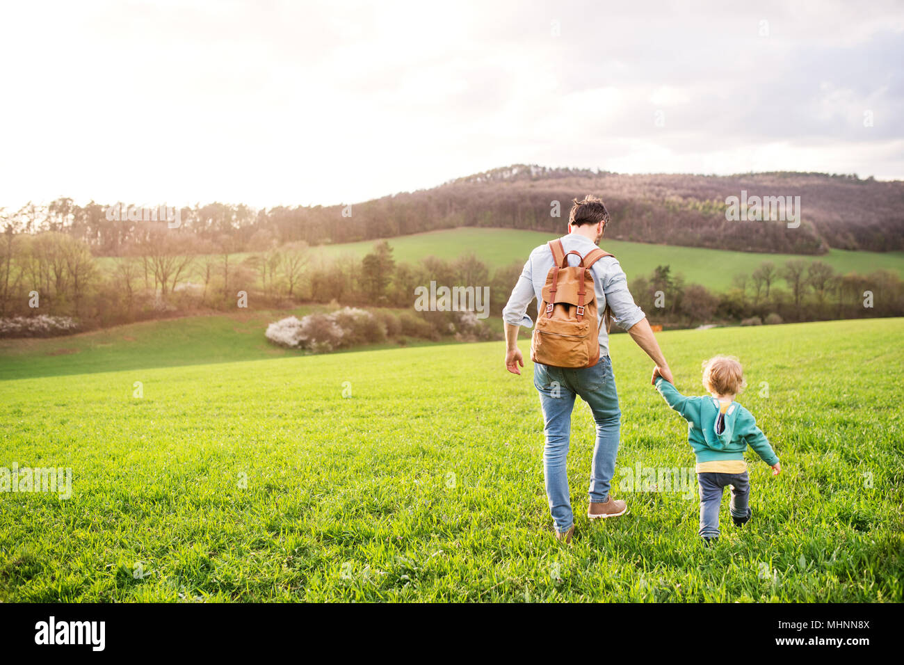 A father with his toddler son on a walk outside in spring nature Stock ...