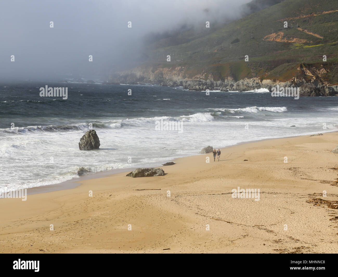couple walking on garrapata state park beach Stock Photo - Alamy