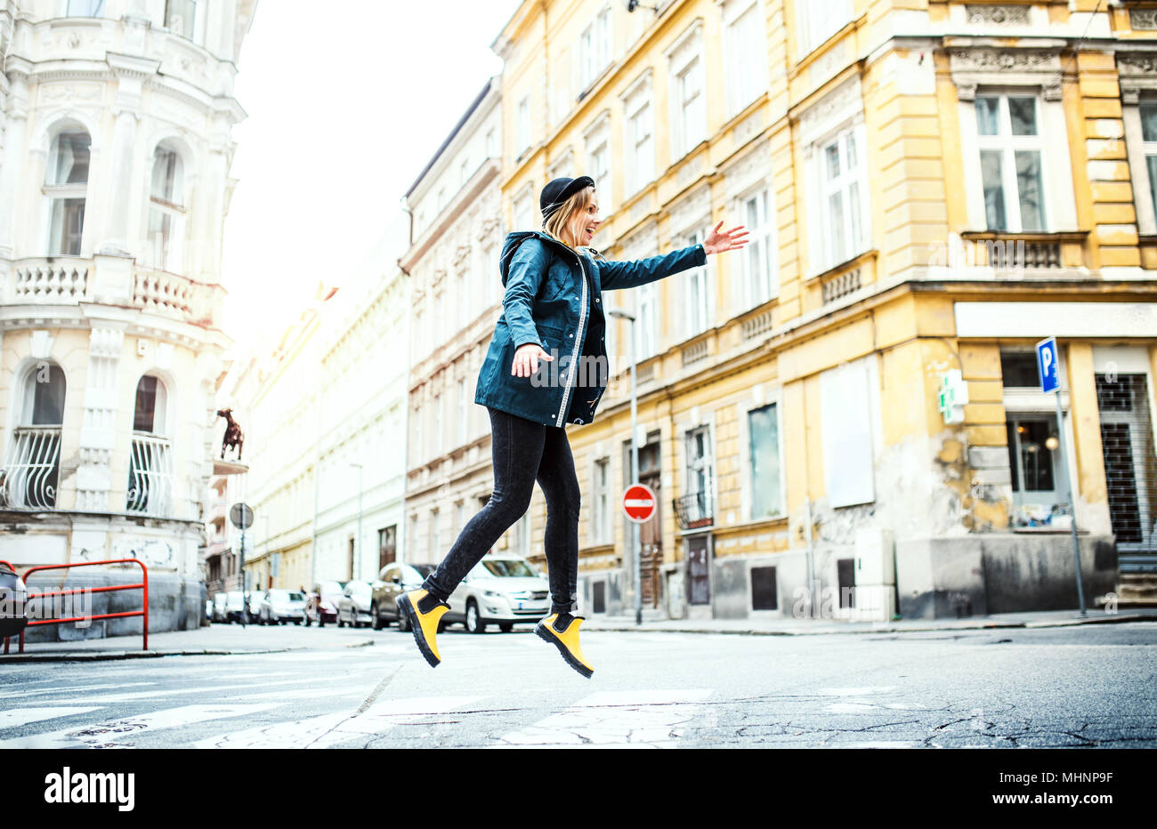 Young woman jumping on the street in town Stock Photo - Alamy