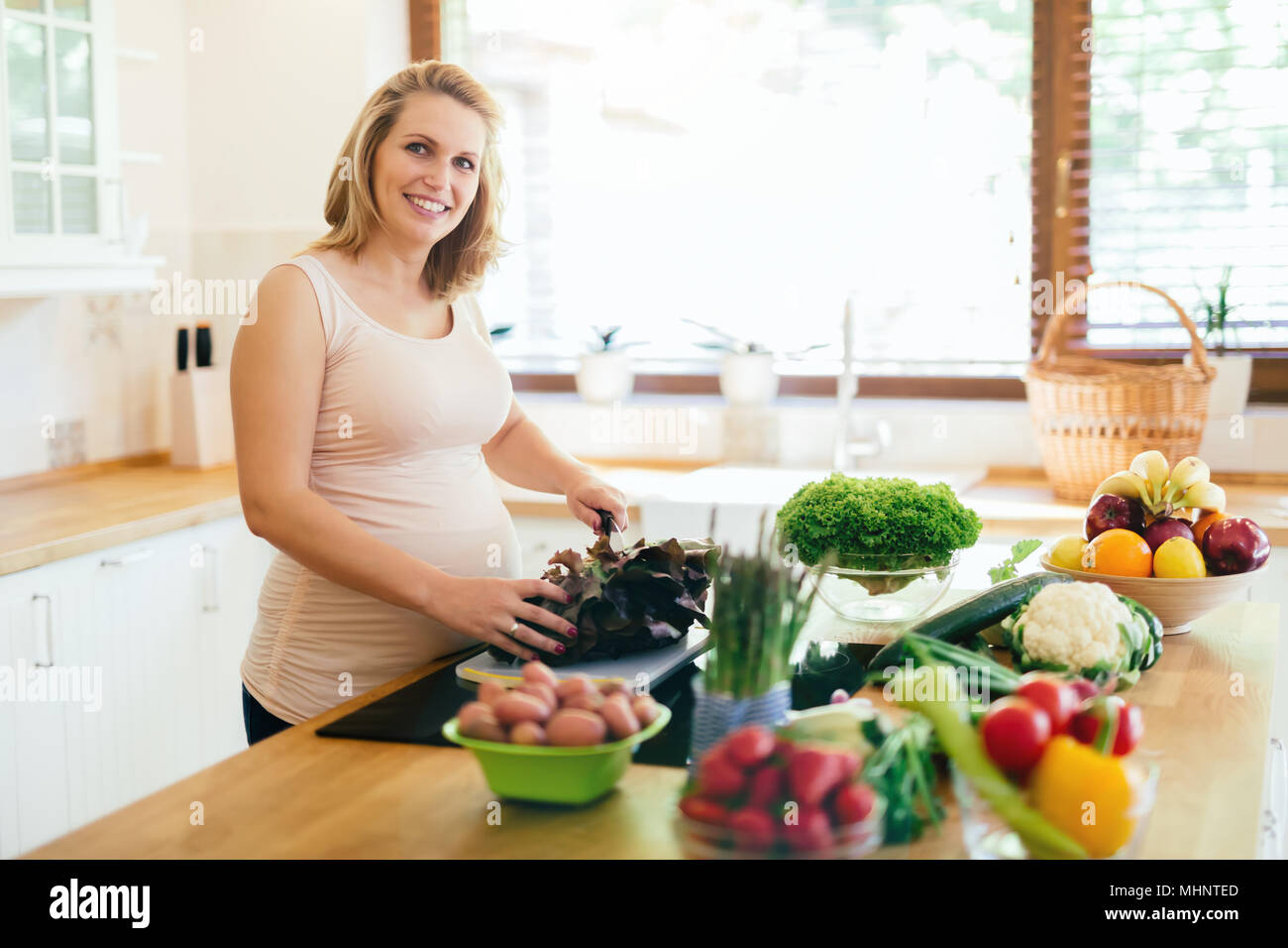 Woman preparing meal on kitchen island Stock Photo - Alamy