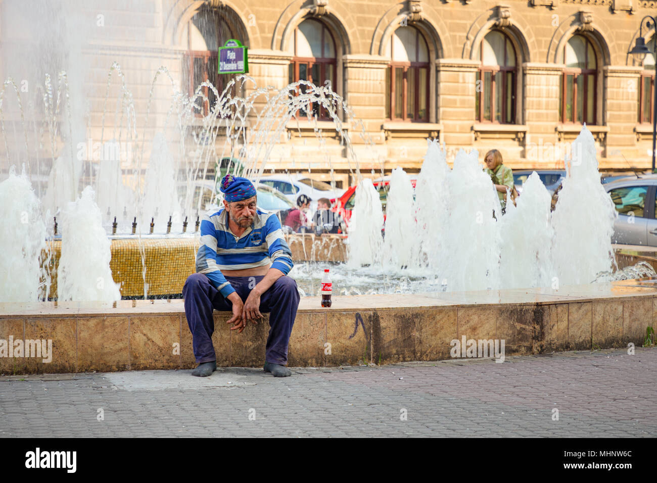 Bucharest, Rumania - 28.04.2018: Homeless man seating on fountain in ...