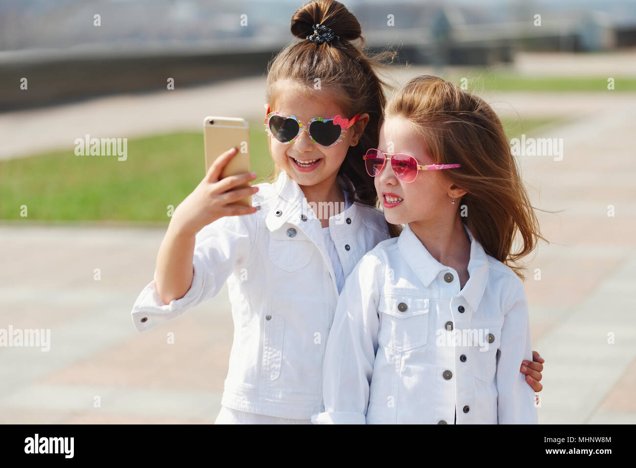 stylish funny little girls on the street Stock Photo - Alamy