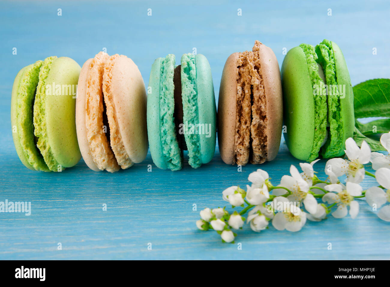 Different types of macaroons. Turquoise, chocolate and green colors ...