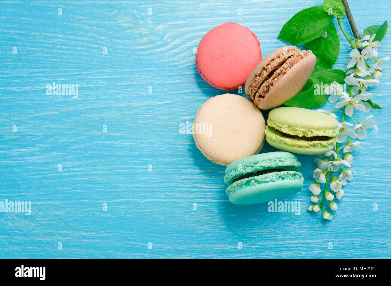 Different types of macaroons. Turquoise, chocolate and green colors ...