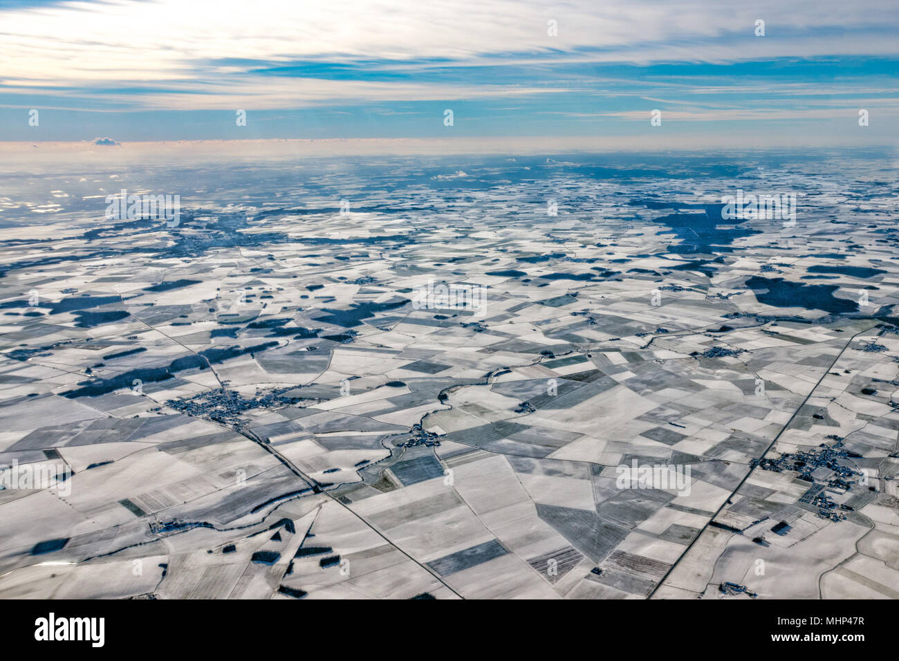 farmed fields covered by snow aerial view landscape in europe France ...