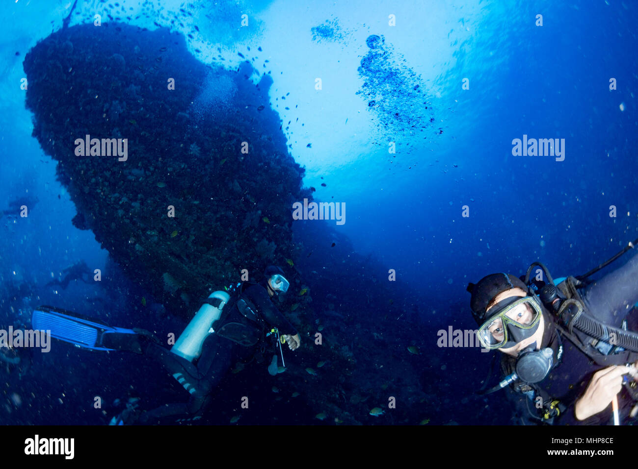 Scuba diver underwater portrait in the deep blue ocean and backlight ...