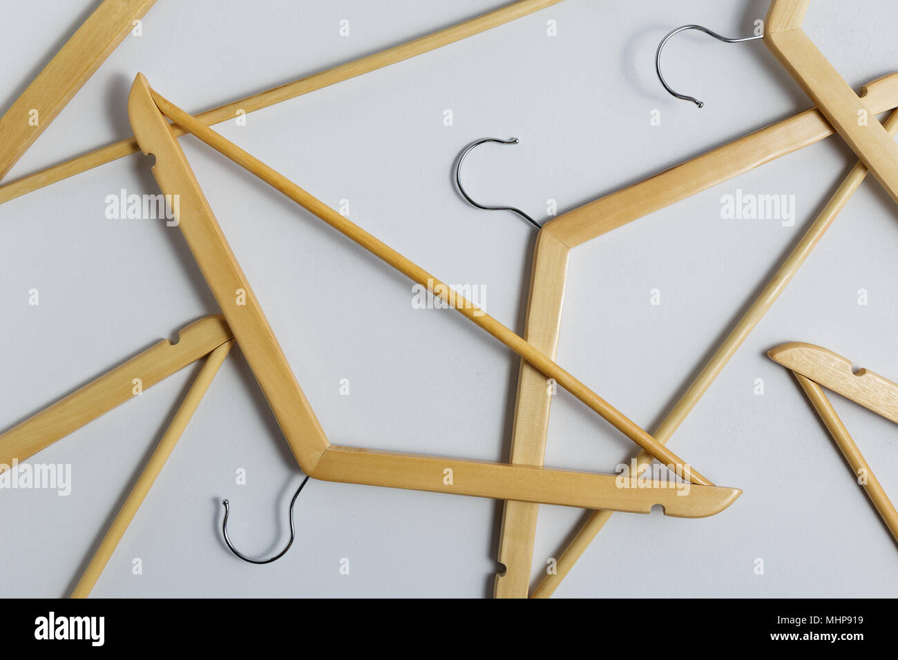 Flat lay of wooden coat hangers on grey background Stock Photo - Alamy