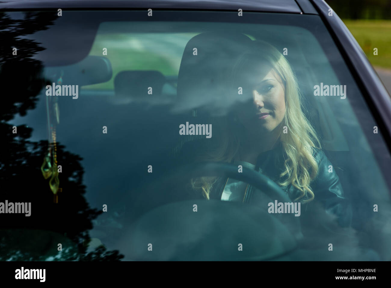 Young woman driver through windscreen hi-res stock photography and ...