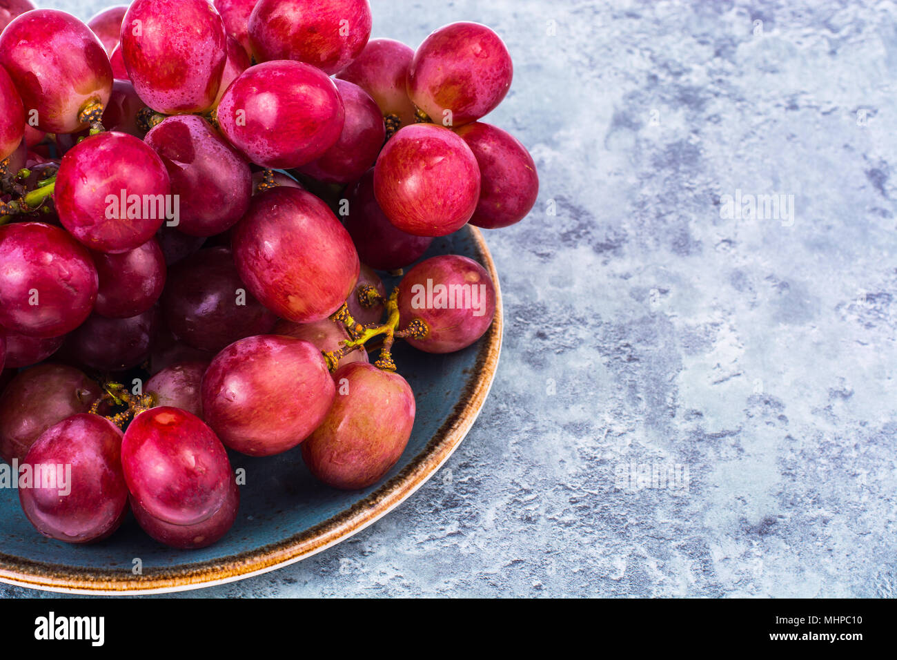 Plate with sweet, ripe red grapes. Studio Photo Stock Photo - Alamy