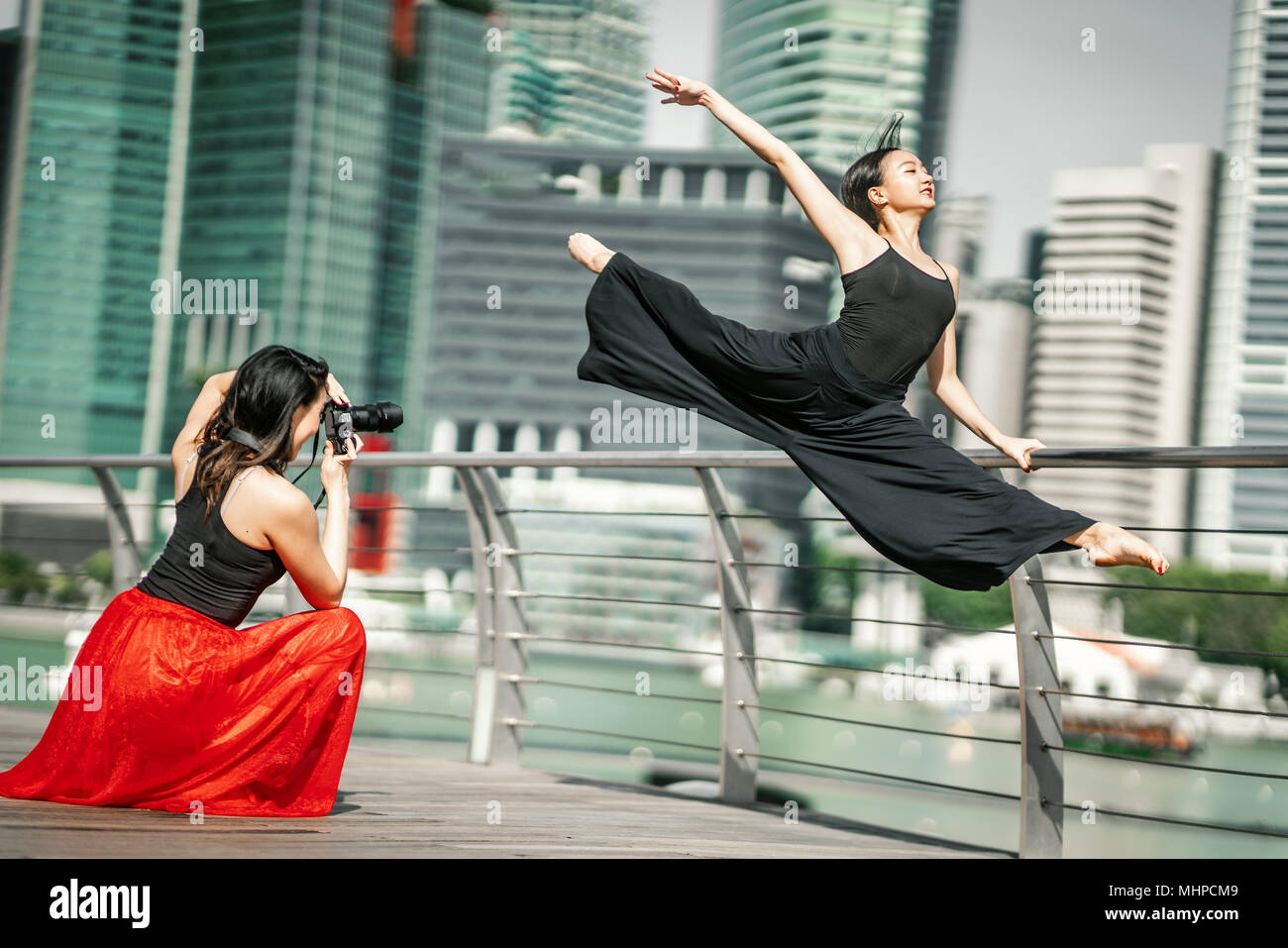 Two beautiful young girls having fun photo shooting on a deck with ...