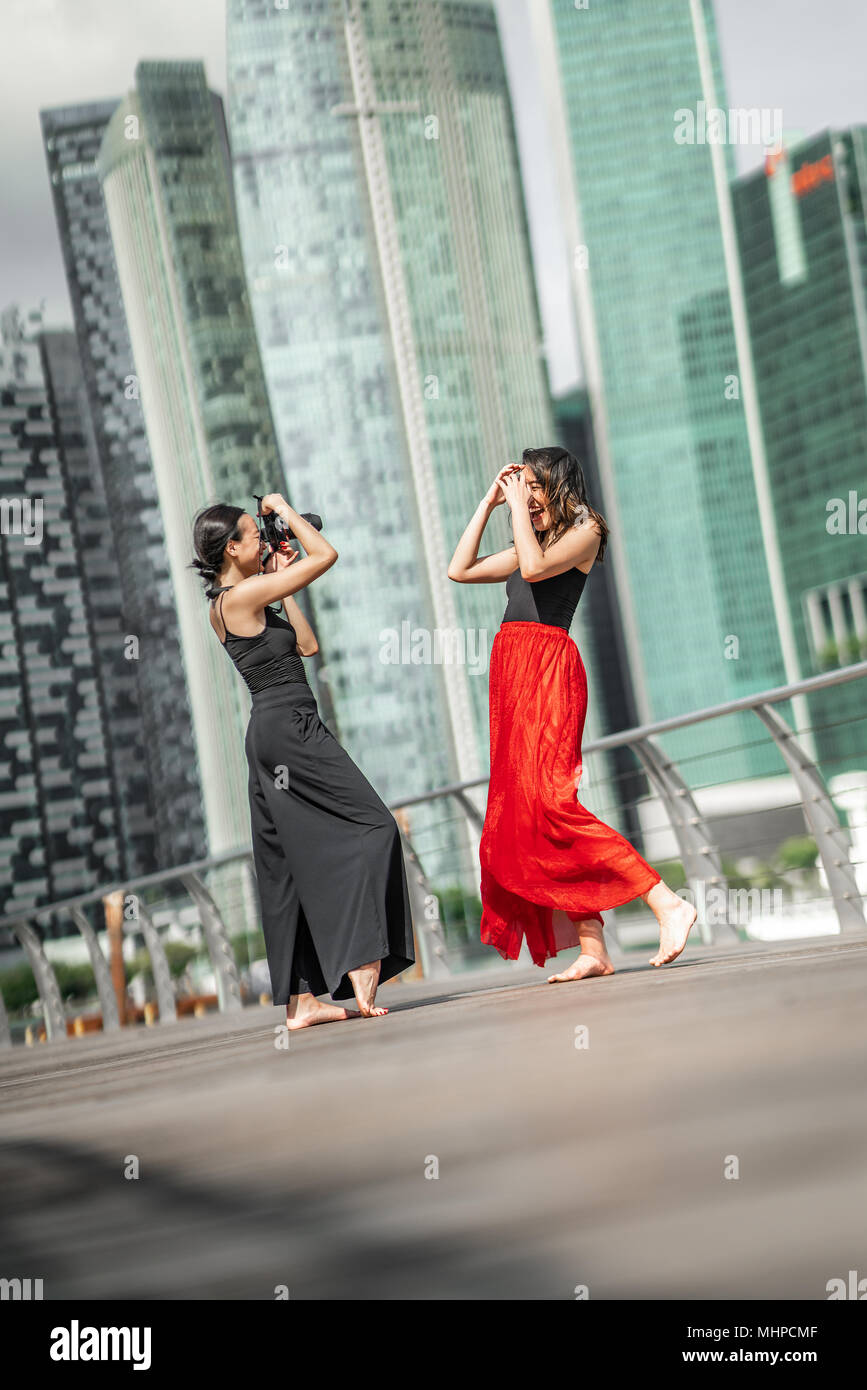 Two beautiful young girls having fun photo shooting on a deck with ...